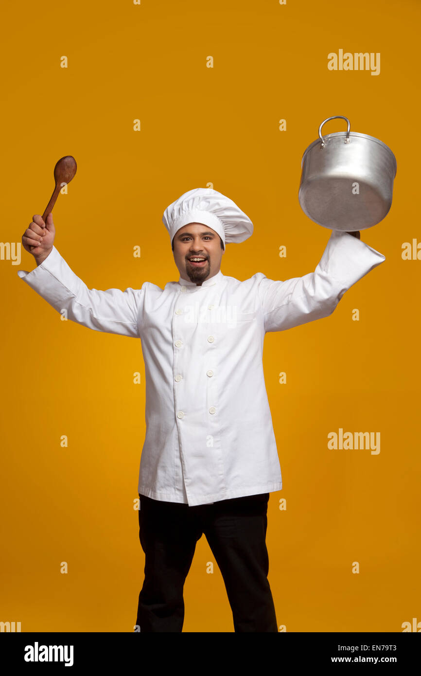 Portrait of chef holding utensil and spoon Stock Photo - Alamy