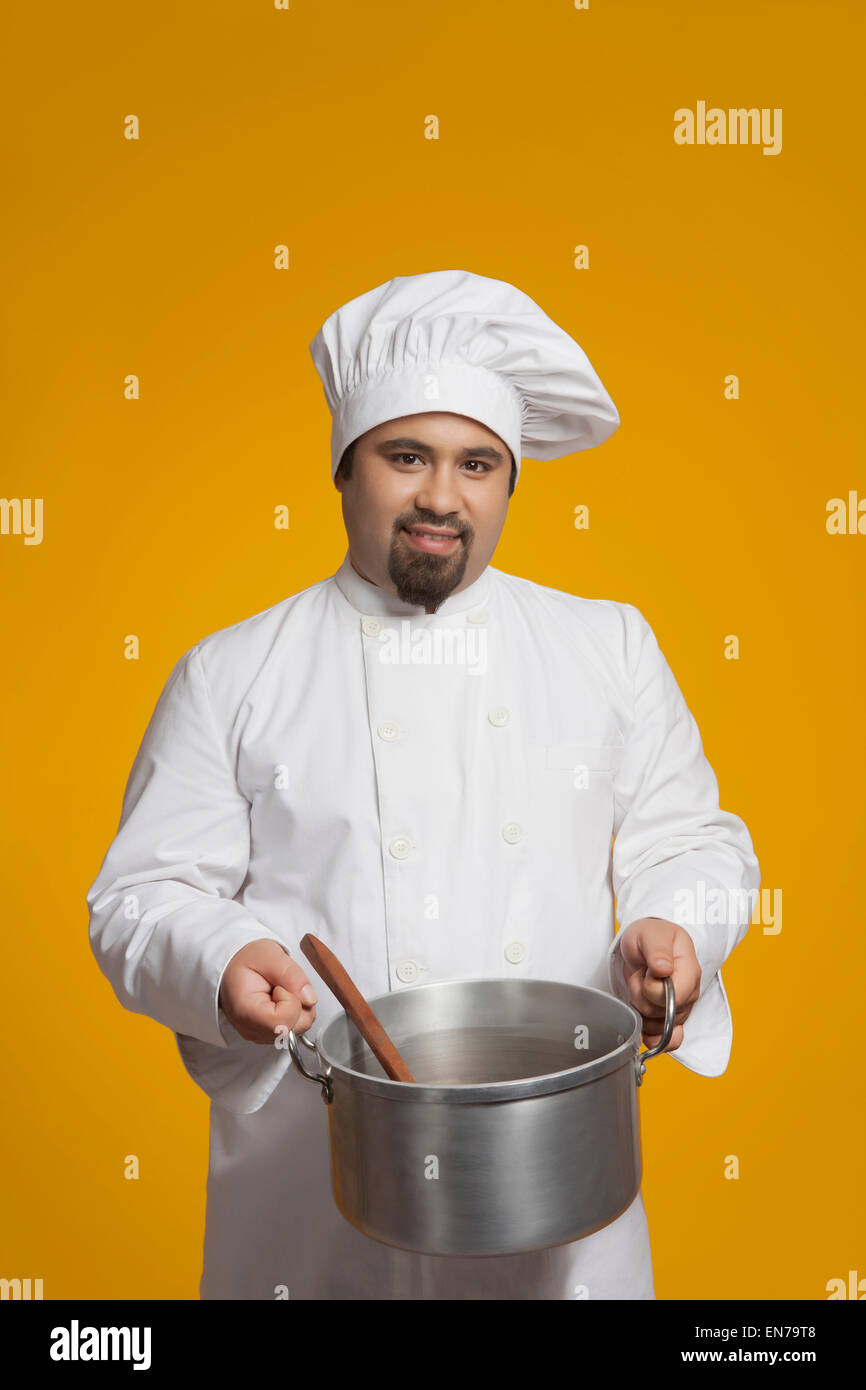 Portrait of chef holding utensil Stock Photo - Alamy