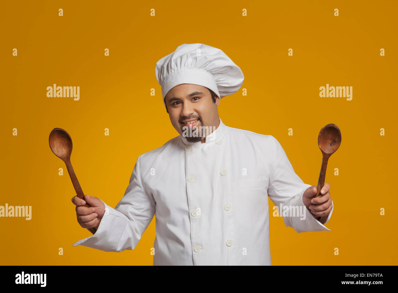 Portrait of chef holding wooden spoons Stock Photo - Alamy
