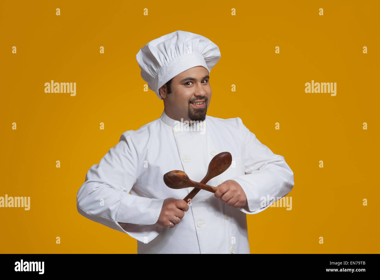 Portrait of chef holding wooden spoons Stock Photo - Alamy