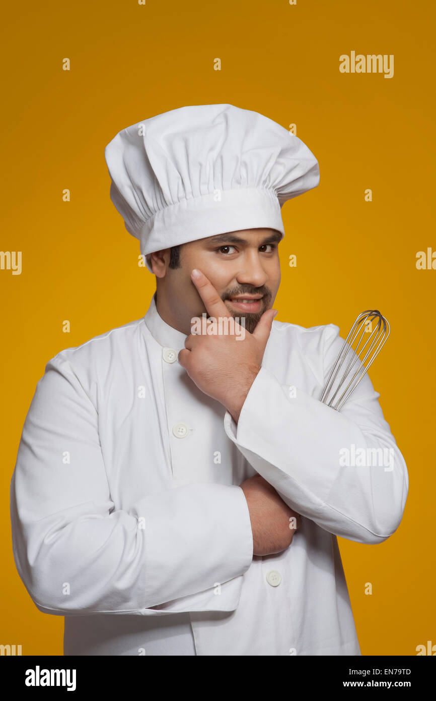 Portrait of chef holding wire whisk Stock Photo - Alamy