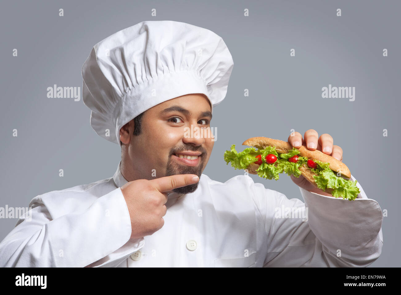 Portrait of chef pointing at sandwich Stock Photo - Alamy