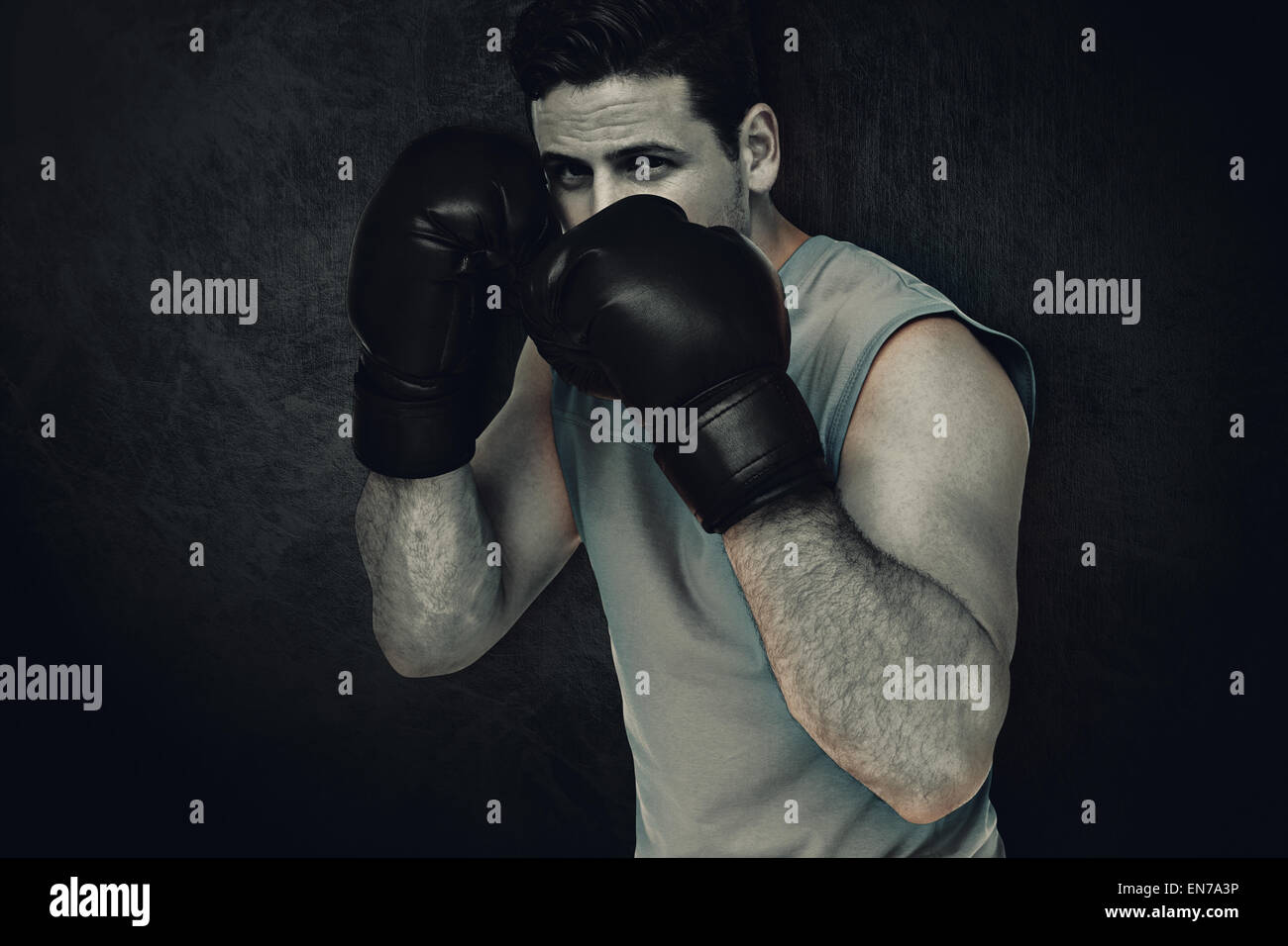Determined male boxer focused on his training over white background ...