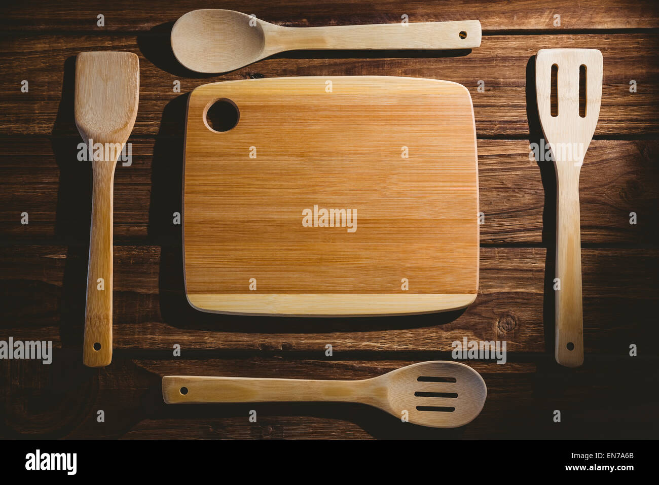 Chopping board with wooden utensils Stock Photo - Alamy