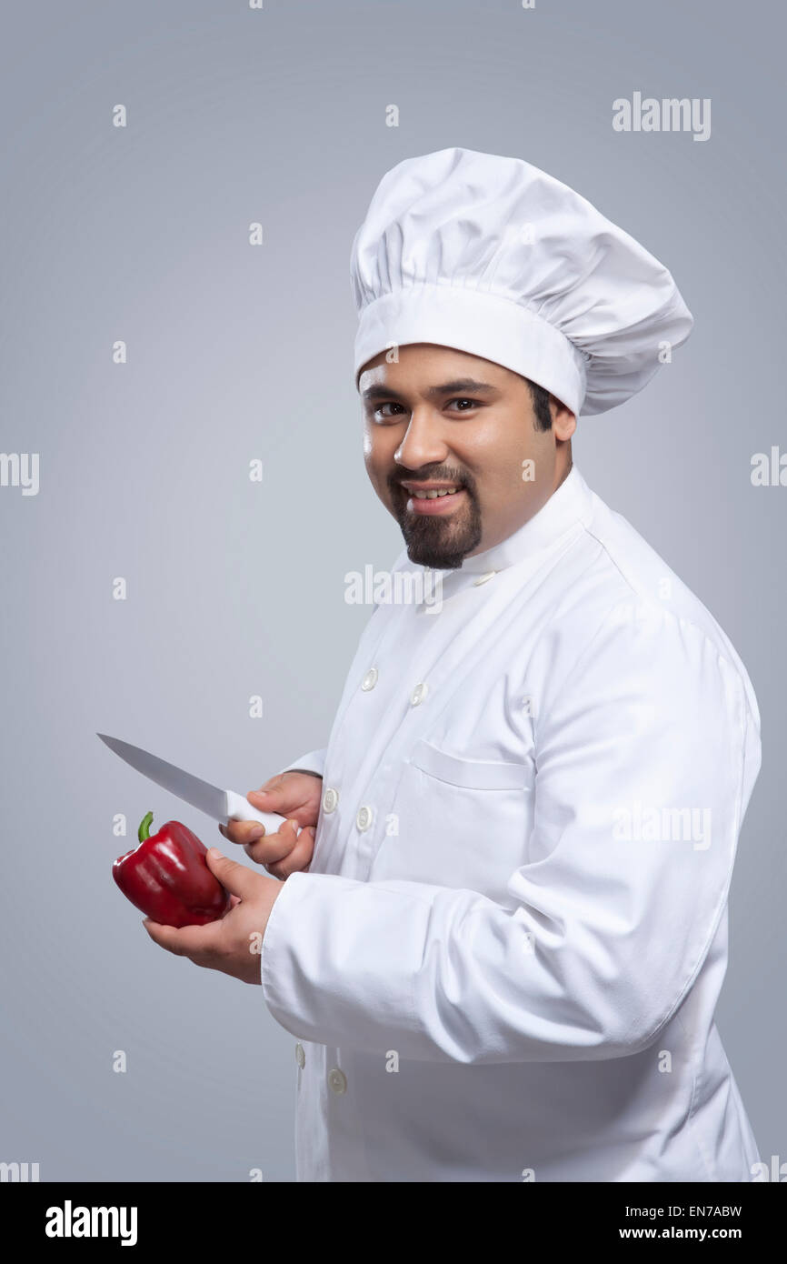Portrait of chef with capsicum and knife Stock Photo - Alamy