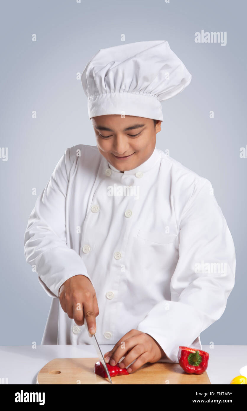 Chef cutting capsicum with knife Stock Photo - Alamy