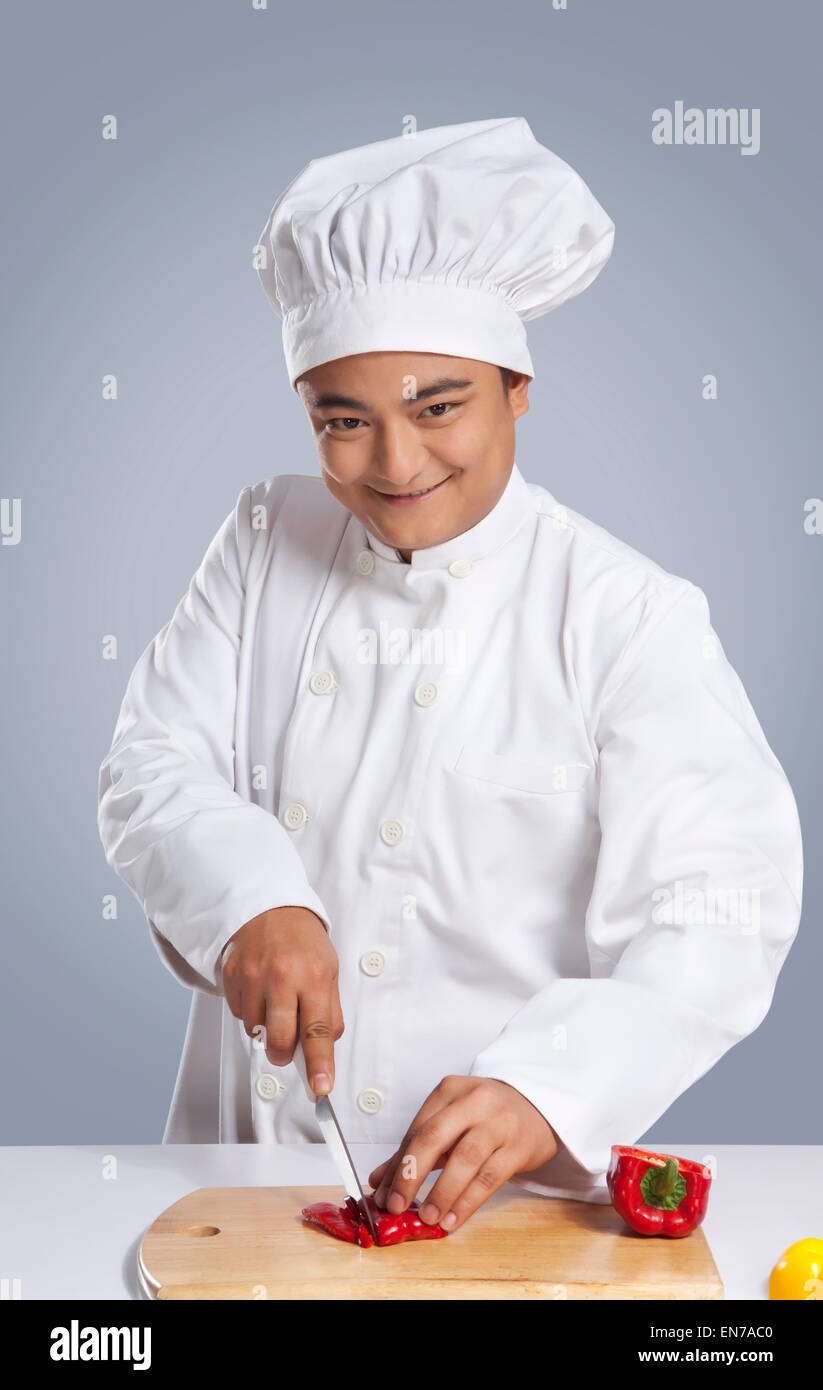 Portrait of chef cutting capsicum Stock Photo - Alamy