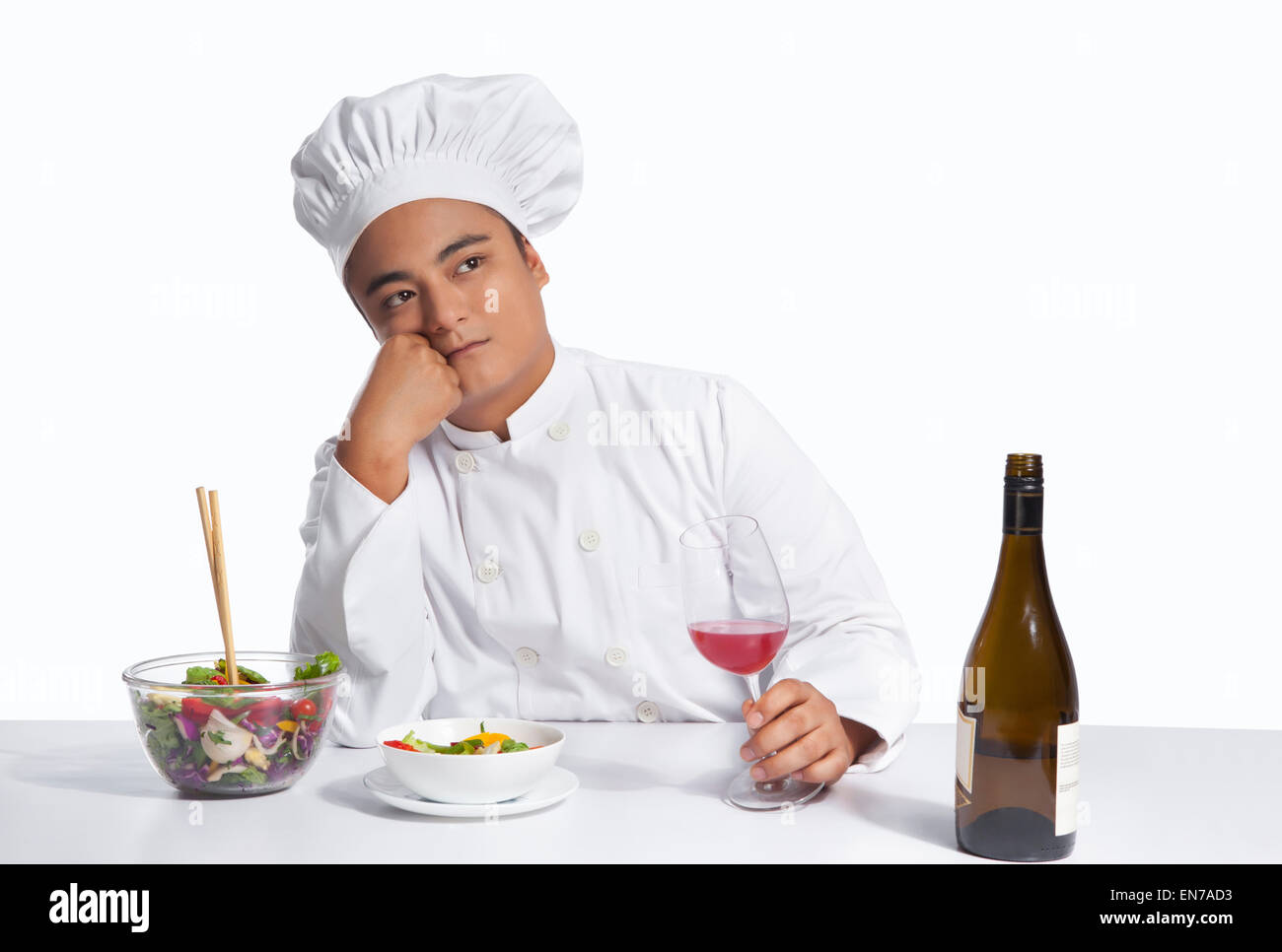 Chef with glass of wine thinking Stock Photo - Alamy