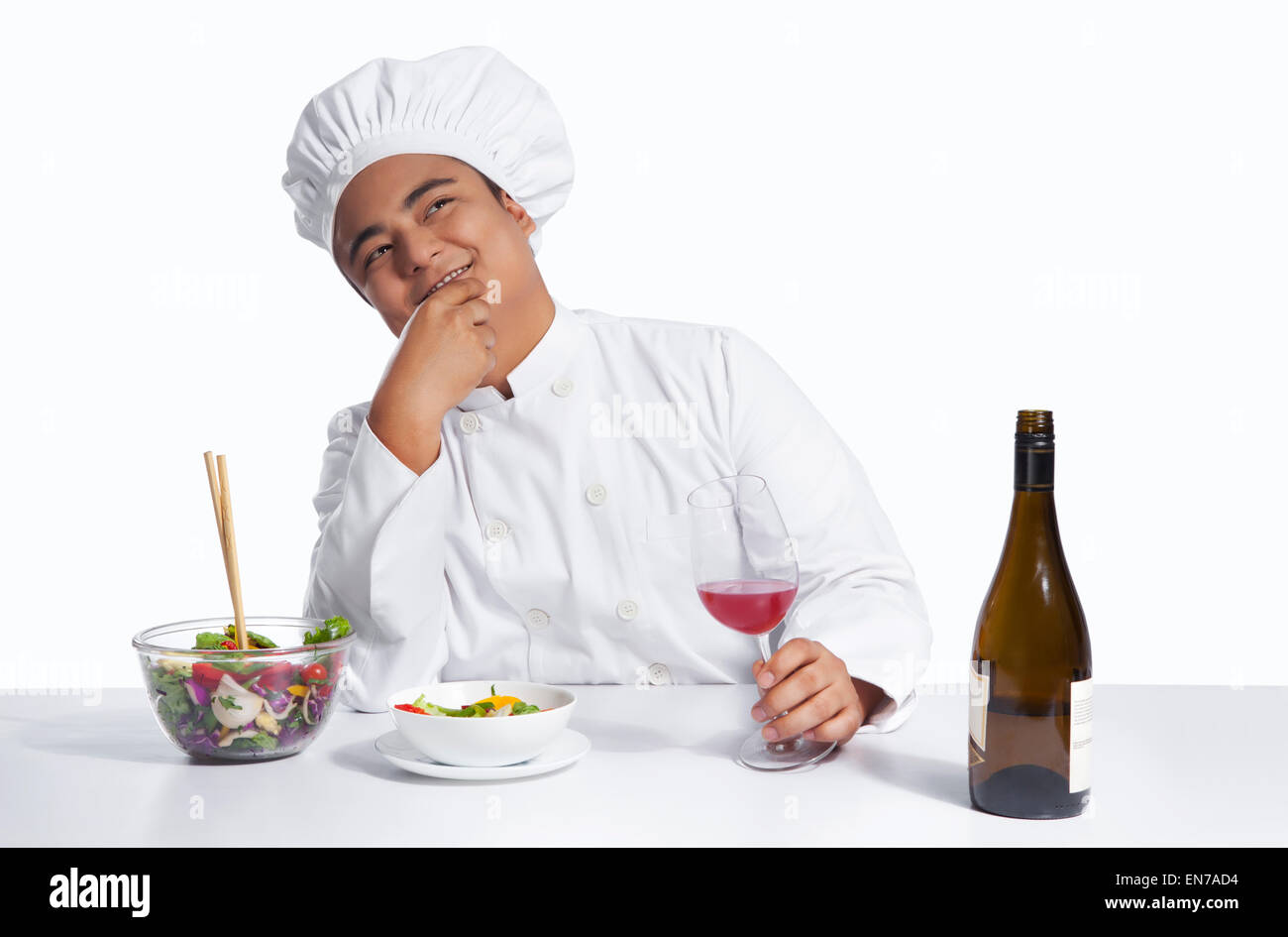 Chef with glass of wine thinking Stock Photo - Alamy