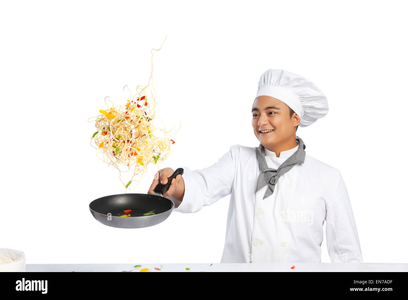Chef tossing food in frying pan Stock Photo - Alamy