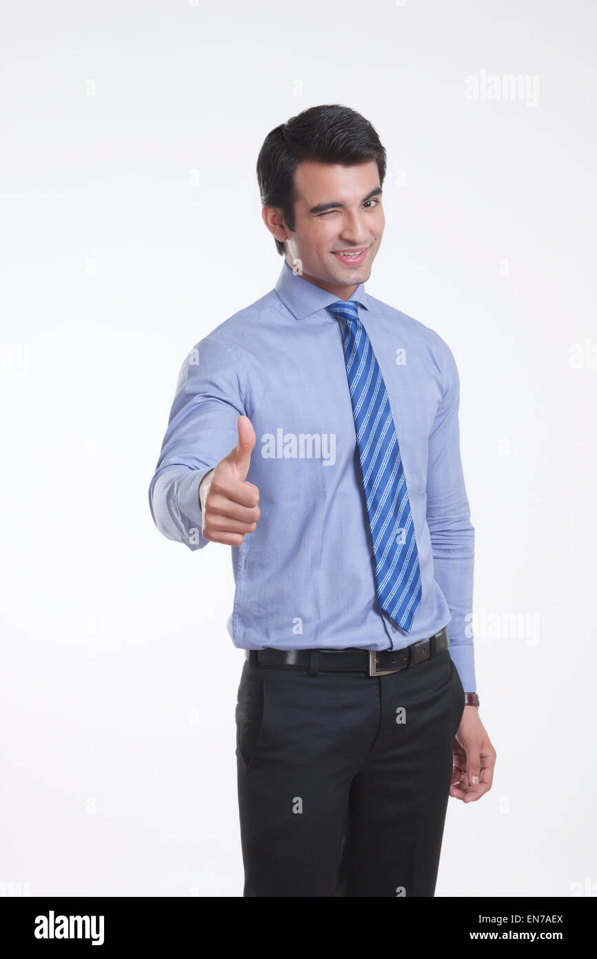 Portrait of a male executive giving thumbs up Stock Photo - Alamy