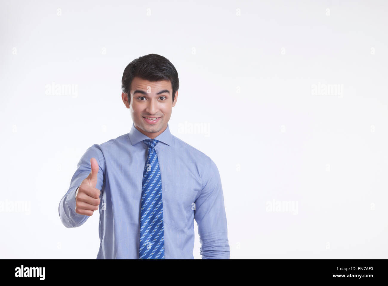 Portrait of a male executive giving thumbs up Stock Photo - Alamy