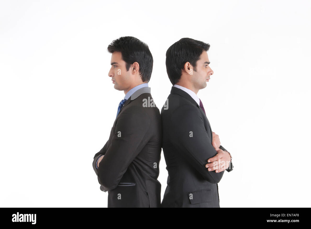 Two businessmen standing back to back Stock Photo - Alamy