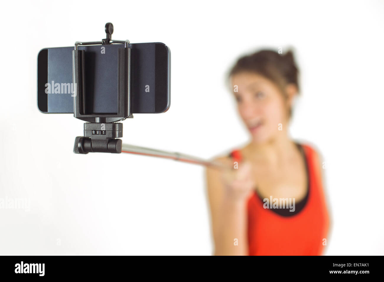 Casual brunette using selfie stick Stock Photo - Alamy