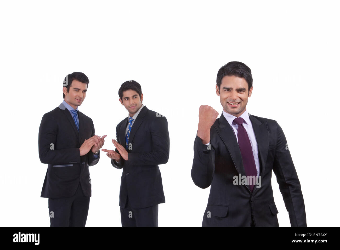 Colleagues clap as fellow businessman rejoices Stock Photo - Alamy