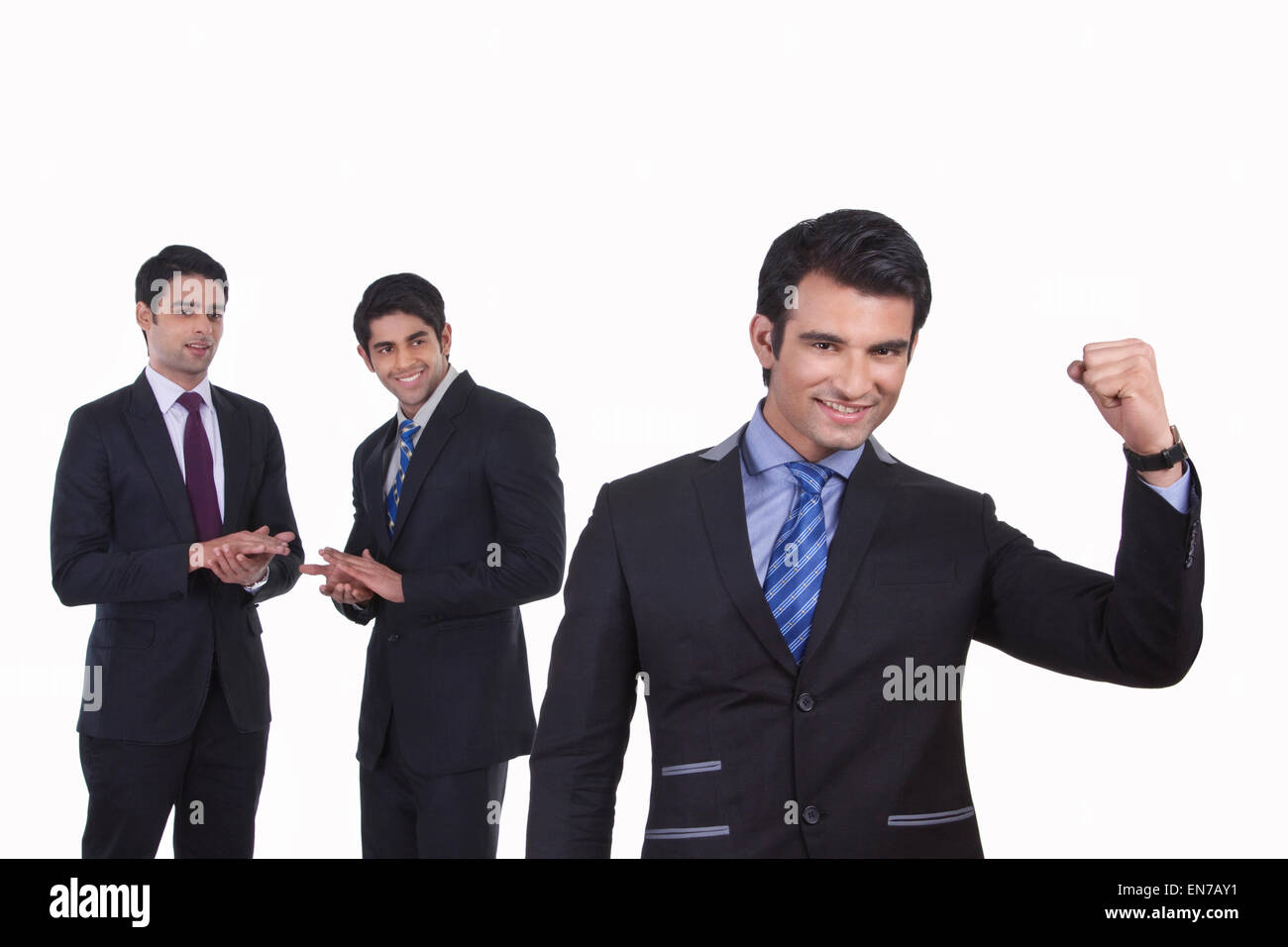 Colleagues clap as fellow businessman rejoices Stock Photo - Alamy