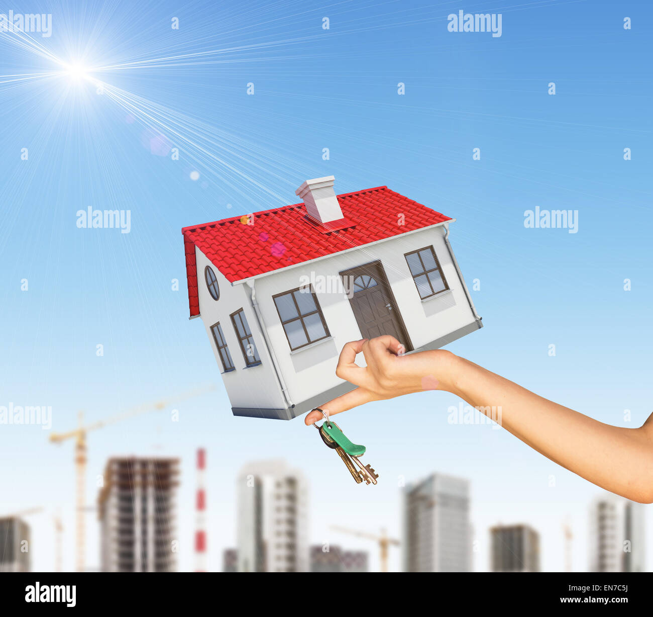 House and keys in womans left hand with cityscape Stock Photo - Alamy
