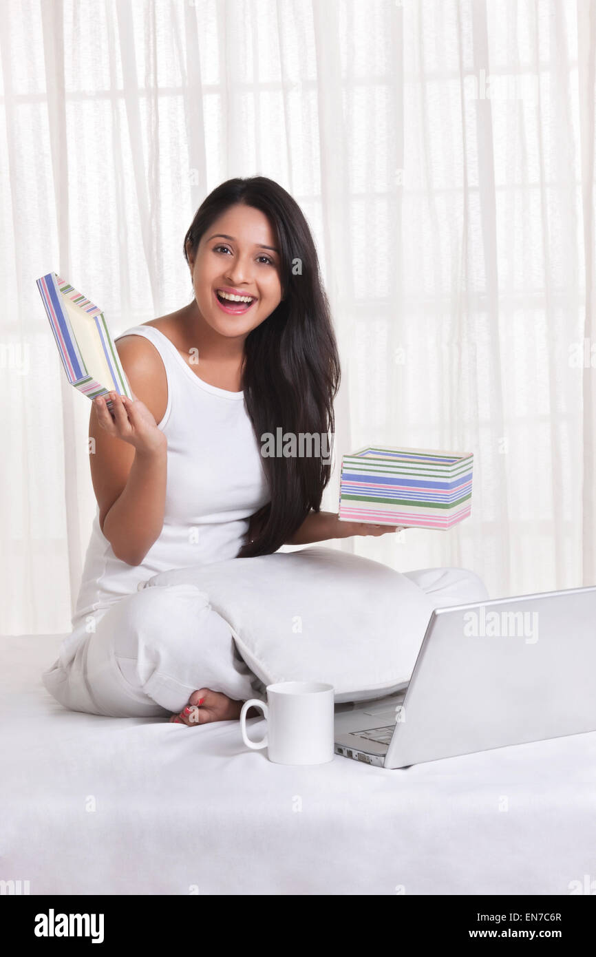 Young WOMEN opening a present Stock Photo - Alamy