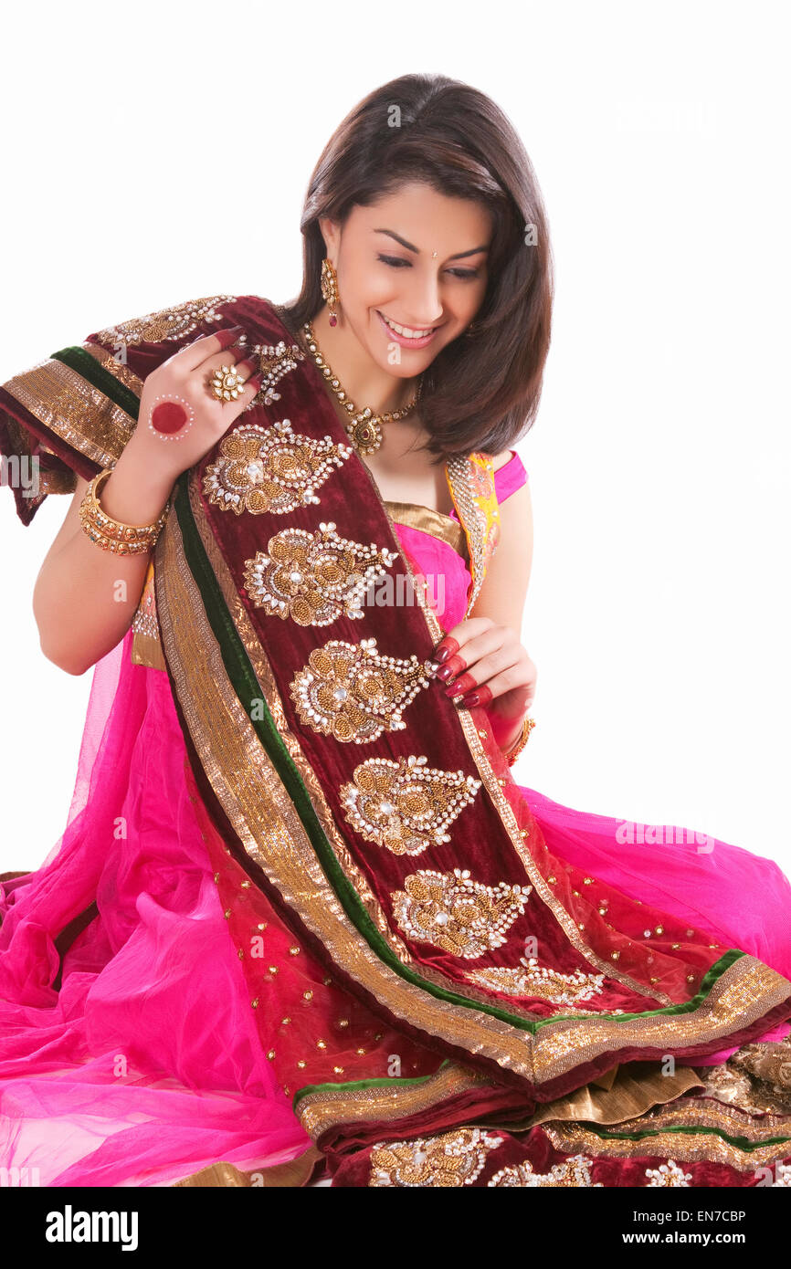 Beautiful woman looking at a saree Stock Photo - Alamy