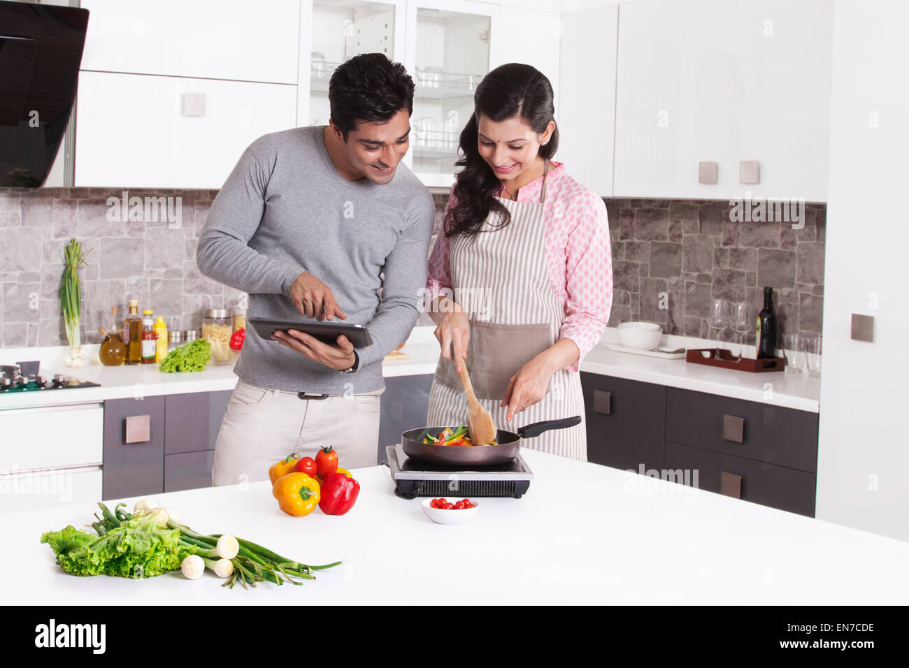 Man giving cooking tips from digital tablet Stock Photo - Alamy