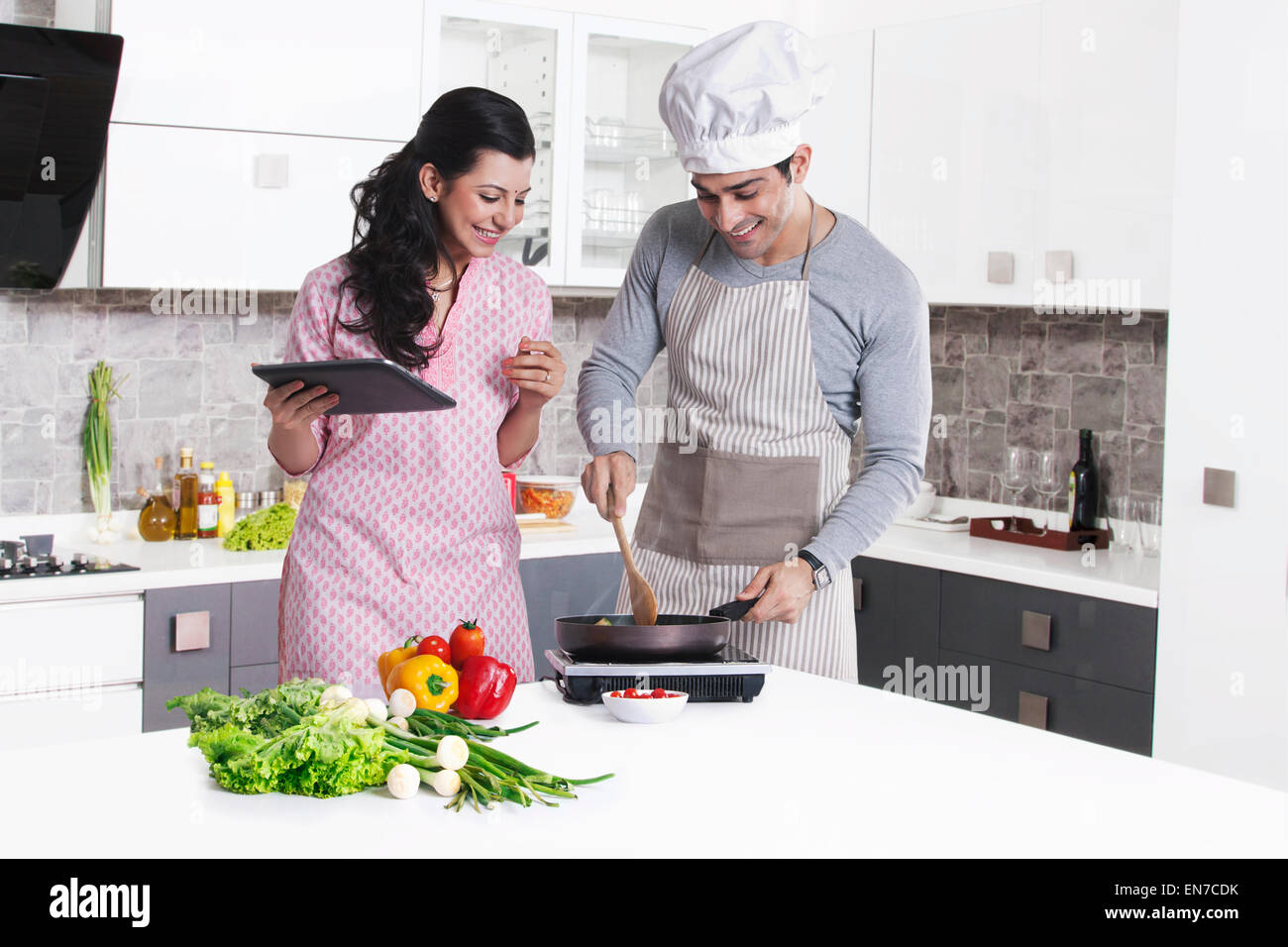 Couple cooking in kitchen Stock Photo - Alamy