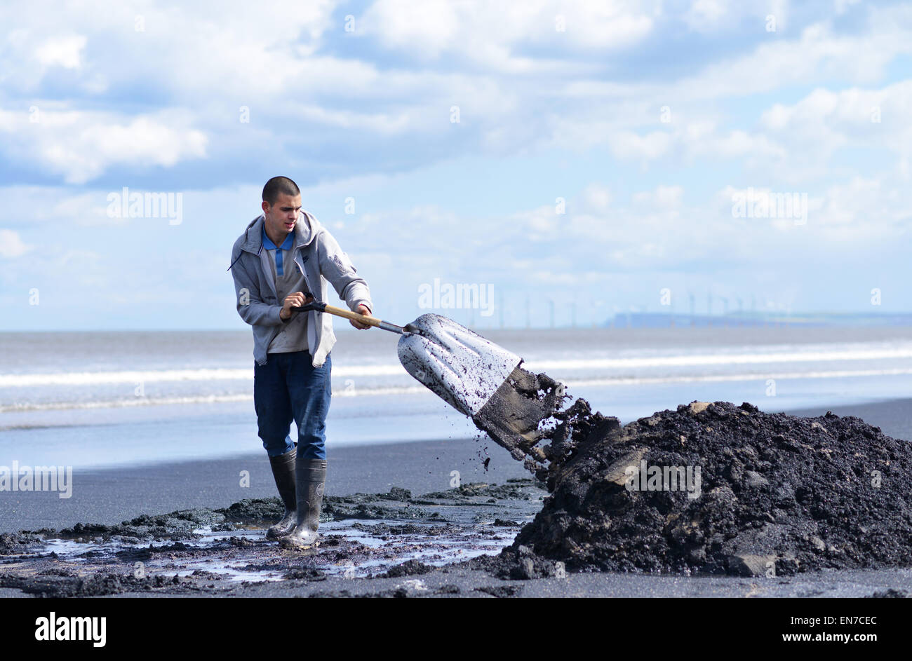 Man collecting sea-coal on Seaton Carew beach near Hartlepool, UK Stock ...