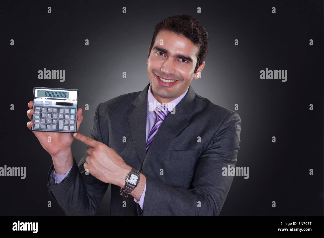 Portrait of businessman with calculator Stock Photo - Alamy
