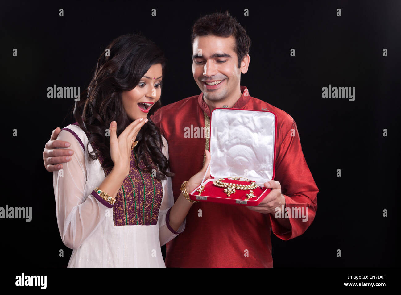Man surprising woman with jewelery Stock Photo - Alamy