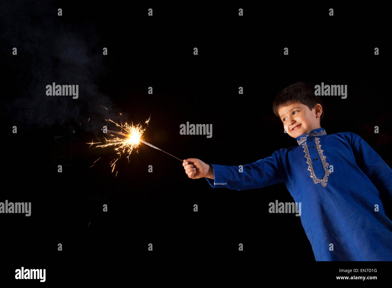 Boy playing with sparkler Stock Photo - Alamy
