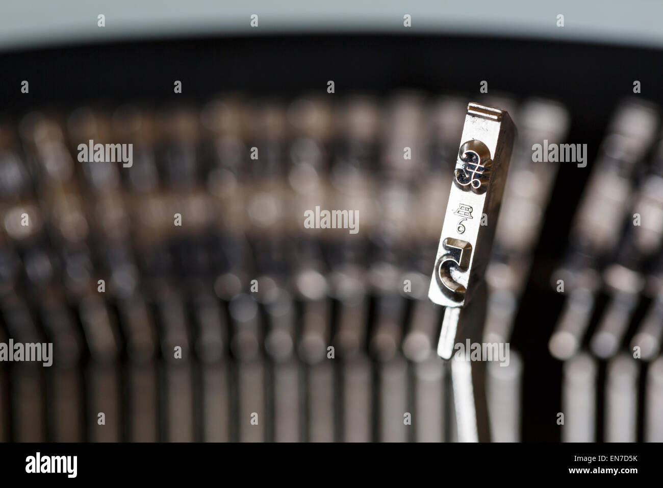 Pound £ symbol and number five on a metal typewriter striking type key ...