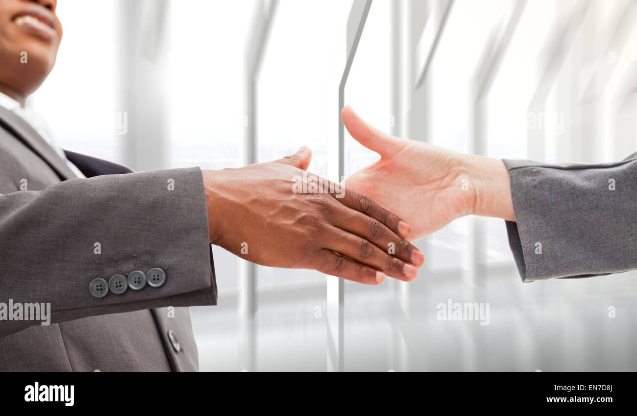 Composite image of businessman going shaking a hand Stock Photo - Alamy