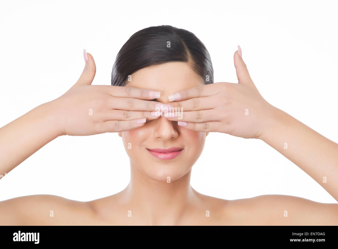 Beautiful woman with hands covering eyes Stock Photo - Alamy