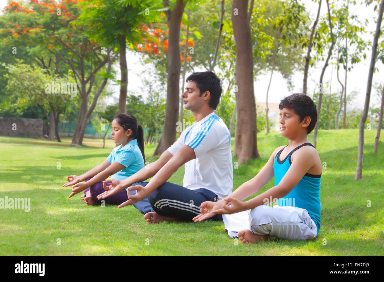Family meditating outdoors Stock Photo - Alamy