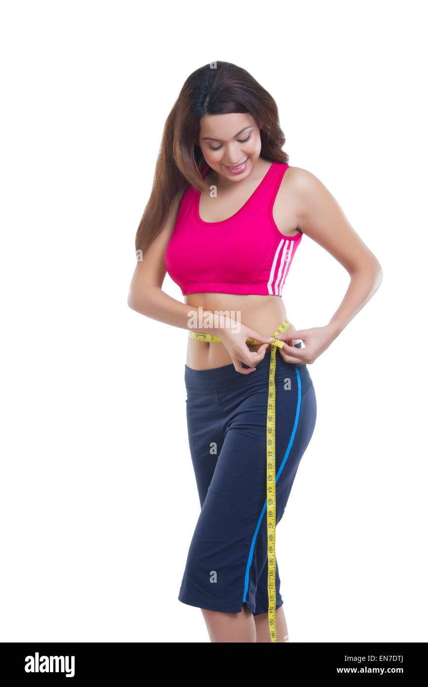 Woman measuring her waist Stock Photo - Alamy
