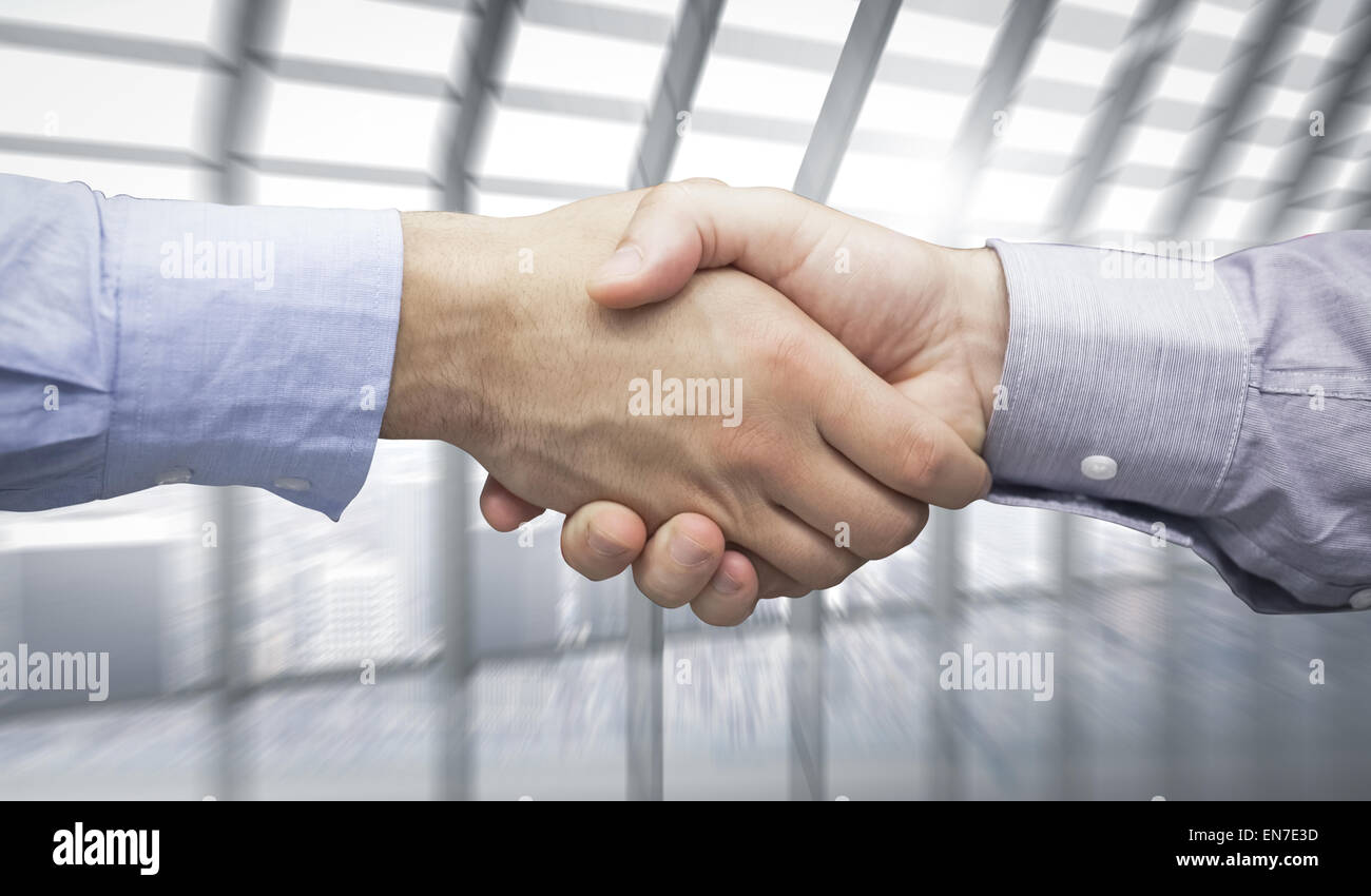 Composite image of hand shake in front of wires Stock Photo - Alamy