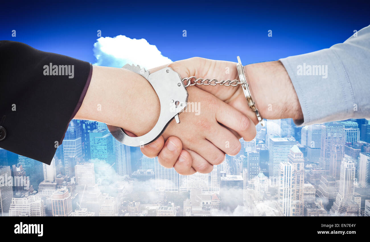 Composite image of business people in handcuffs shaking hands Stock ...