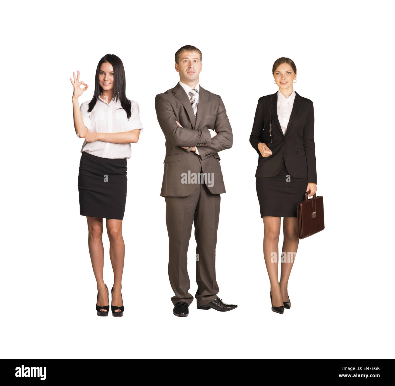 Team leader stands with coworkers in background Stock Photo - Alamy