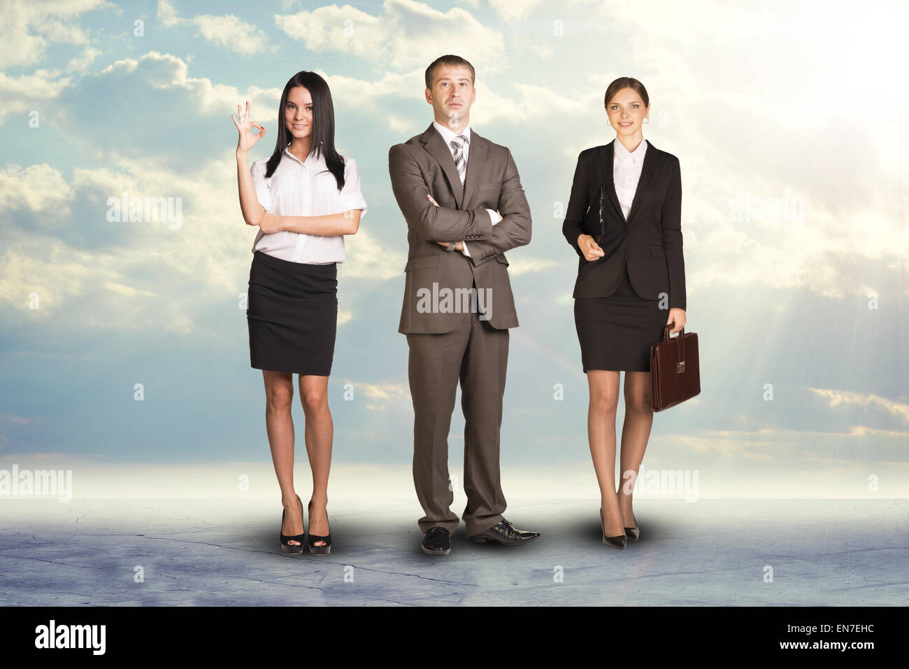 Team leader stands with coworkers in background Stock Photo - Alamy