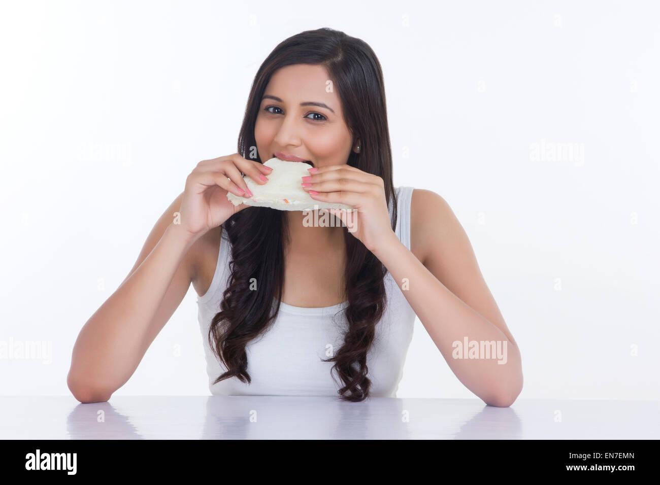 Portrait of woman eating a sandwich Stock Photo - Alamy