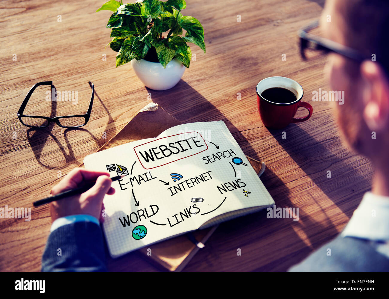 Man Writing Website in Notebook Stock Photo - Alamy