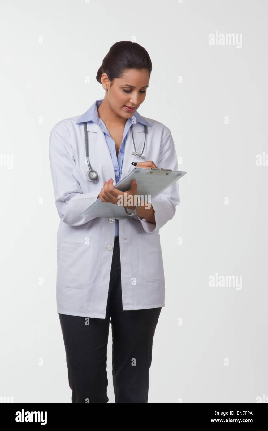 Female doctor writing Stock Photo - Alamy