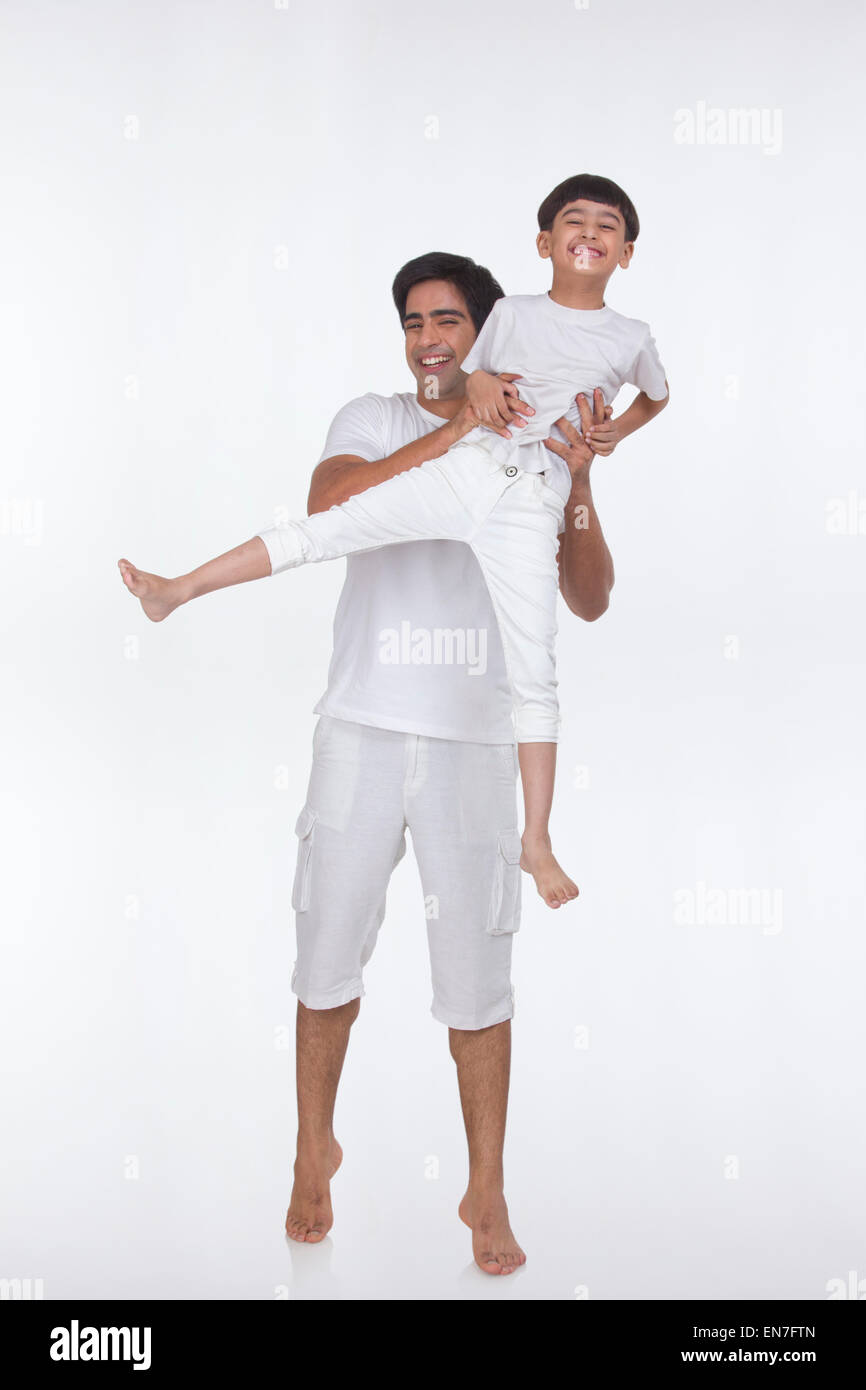Portrait of father lifting son in the air Stock Photo - Alamy