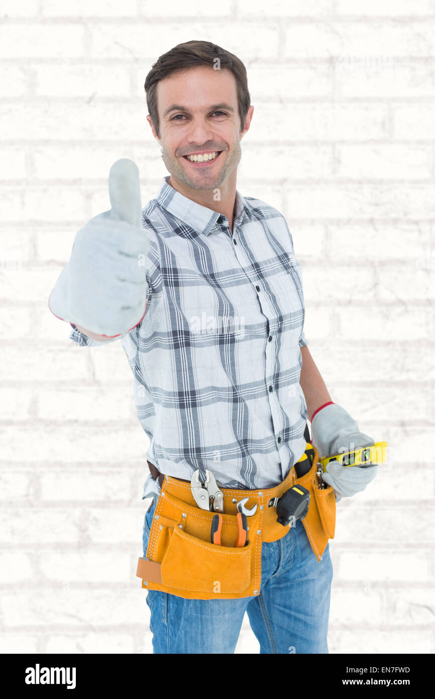 Composite image of happy handyman gesturing thumbs up Stock Photo - Alamy