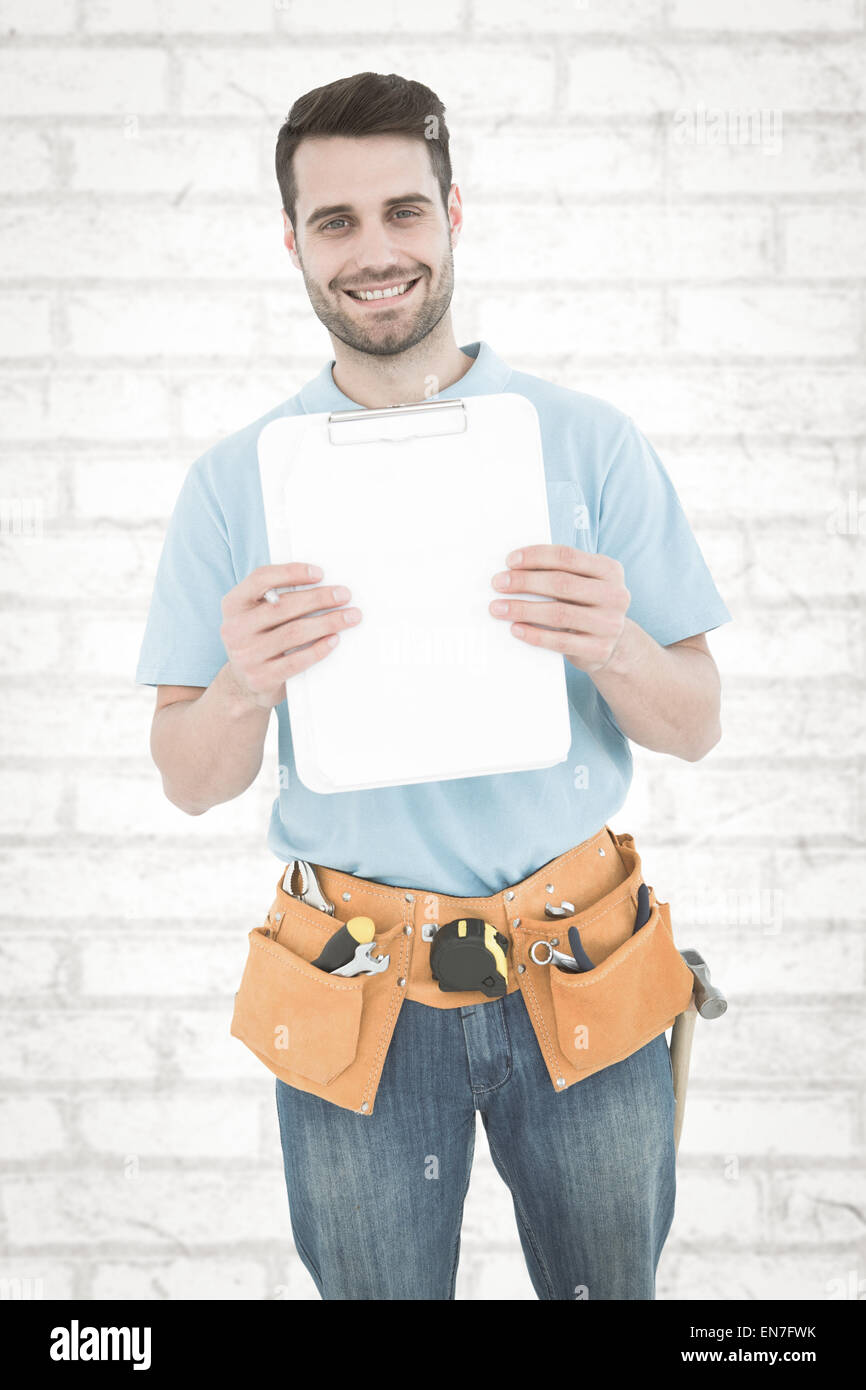 Composite image of construction worker showing blank paper on clipboard ...