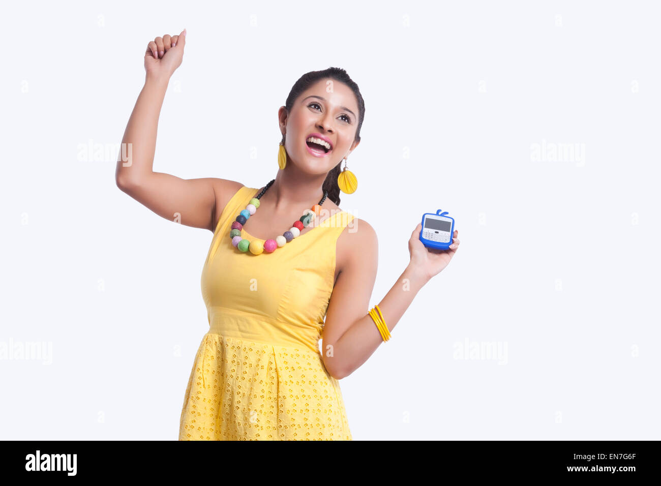 Young woman with mobile phone rejoicing Stock Photo - Alamy