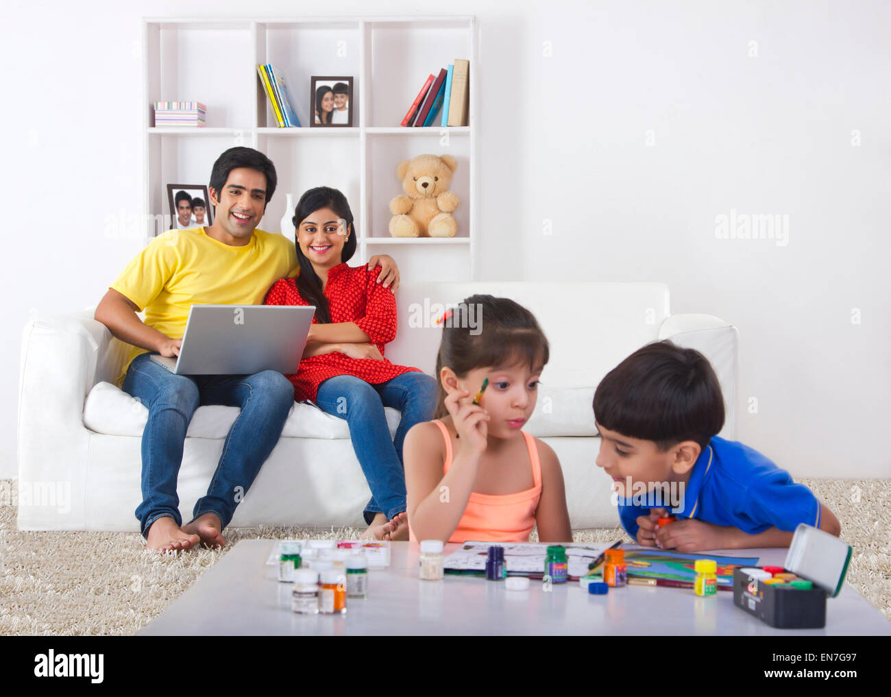 Parents looking at kids painting Stock Photo - Alamy