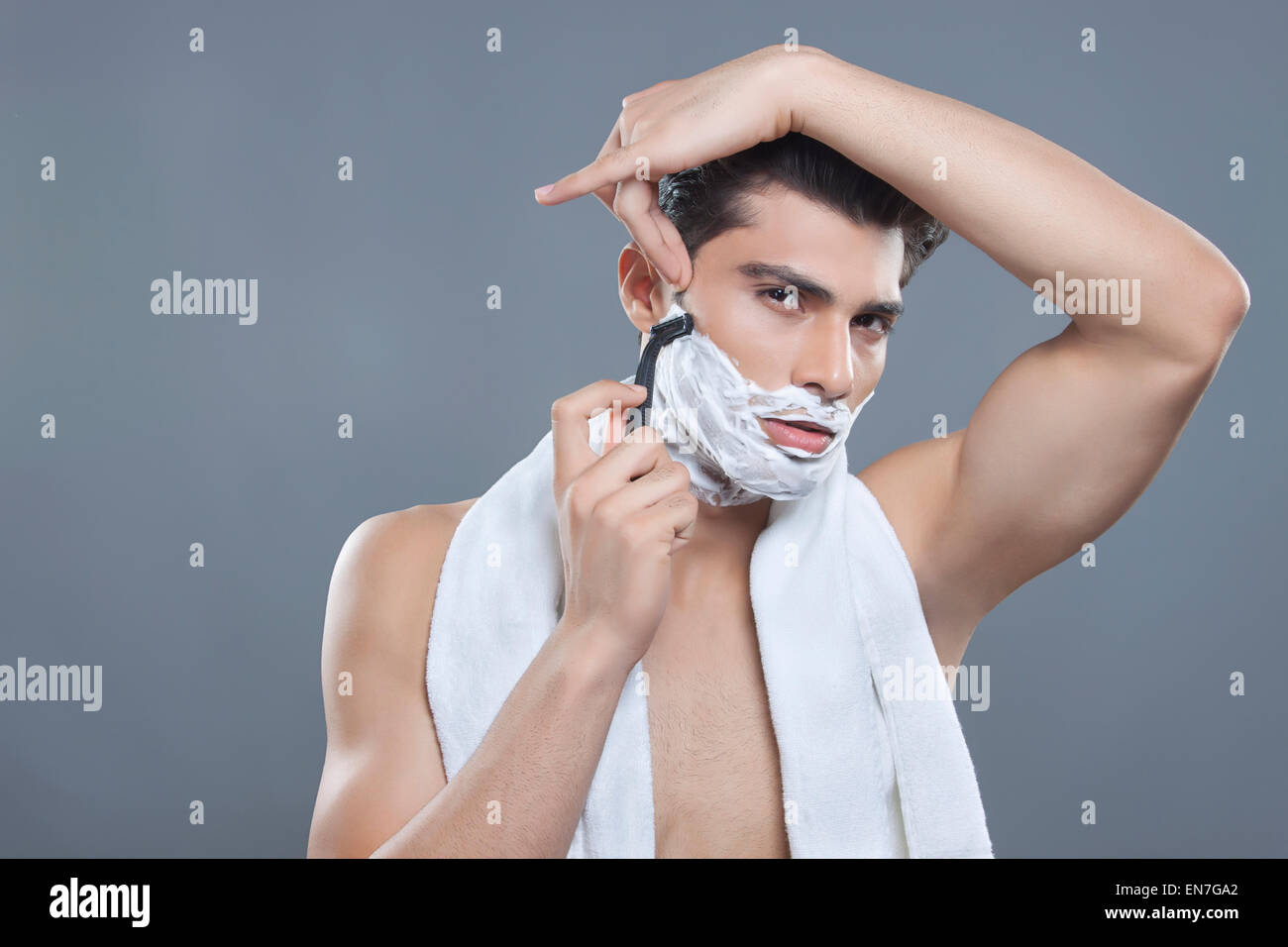 Portrait of young man shaving Stock Photo - Alamy