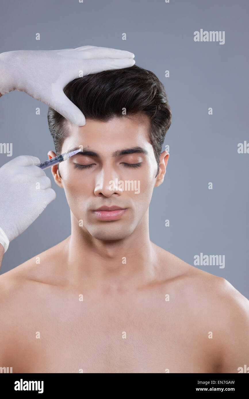 Young man getting botox injection Stock Photo - Alamy