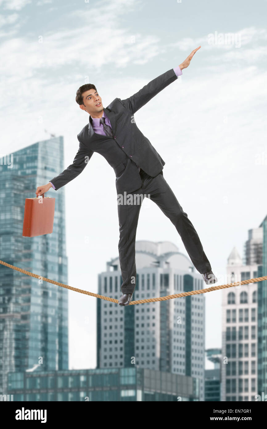 Businessman balancing on rope Stock Photo - Alamy