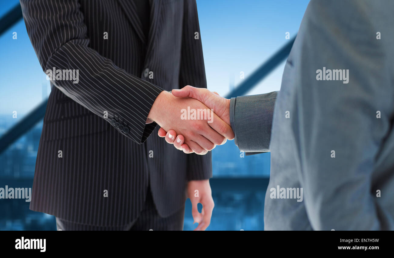 Composite image of business people shaking hands Stock Photo - Alamy